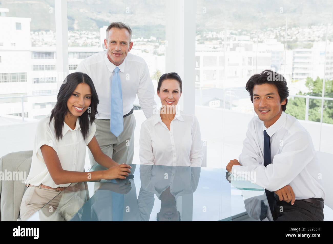 Smiling business team in an office Stock Photo - Alamy