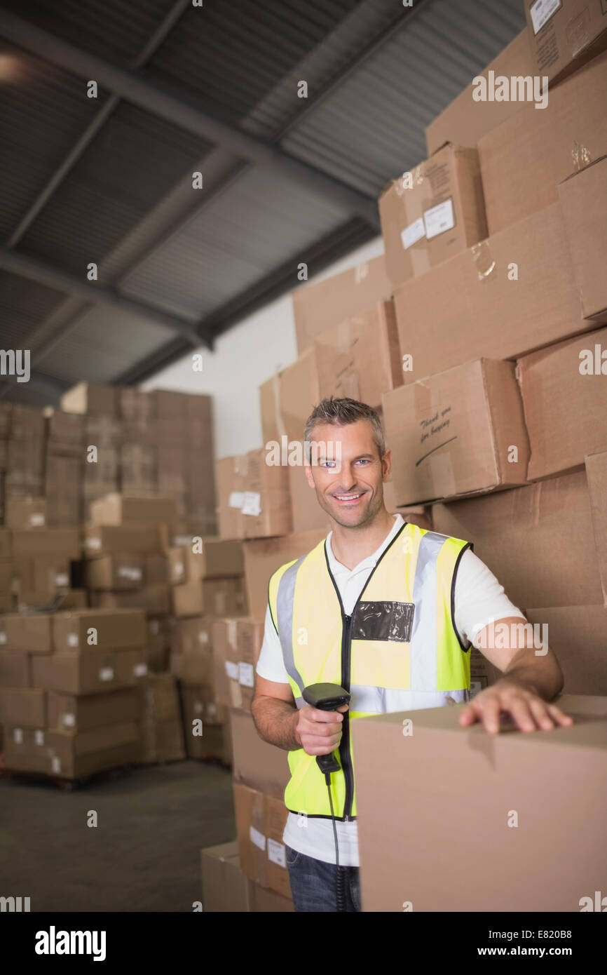 Worker scanning package in warehouse Stock Photo - Alamy