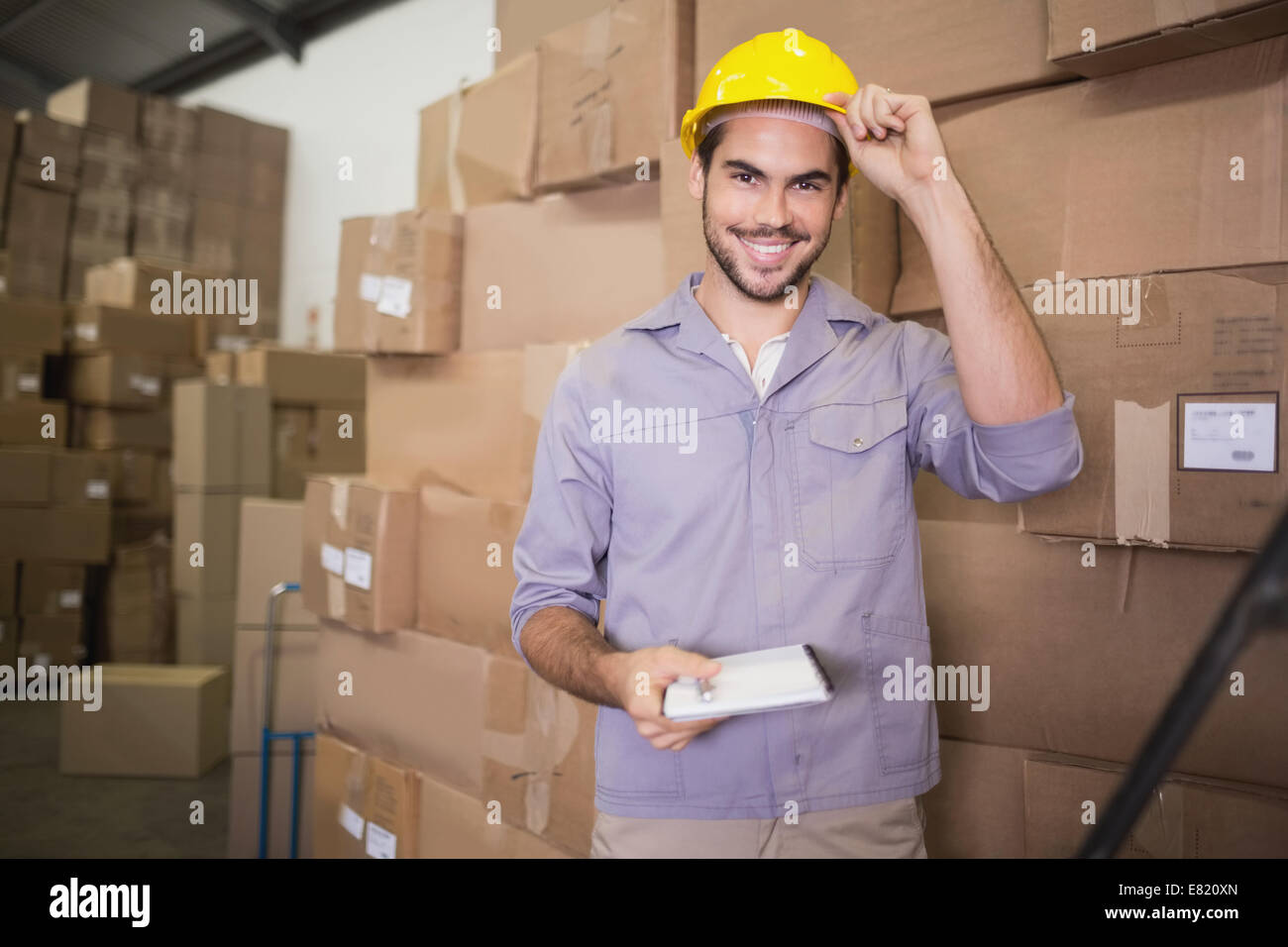 Worker with clipboard in warehouse Stock Photo - Alamy