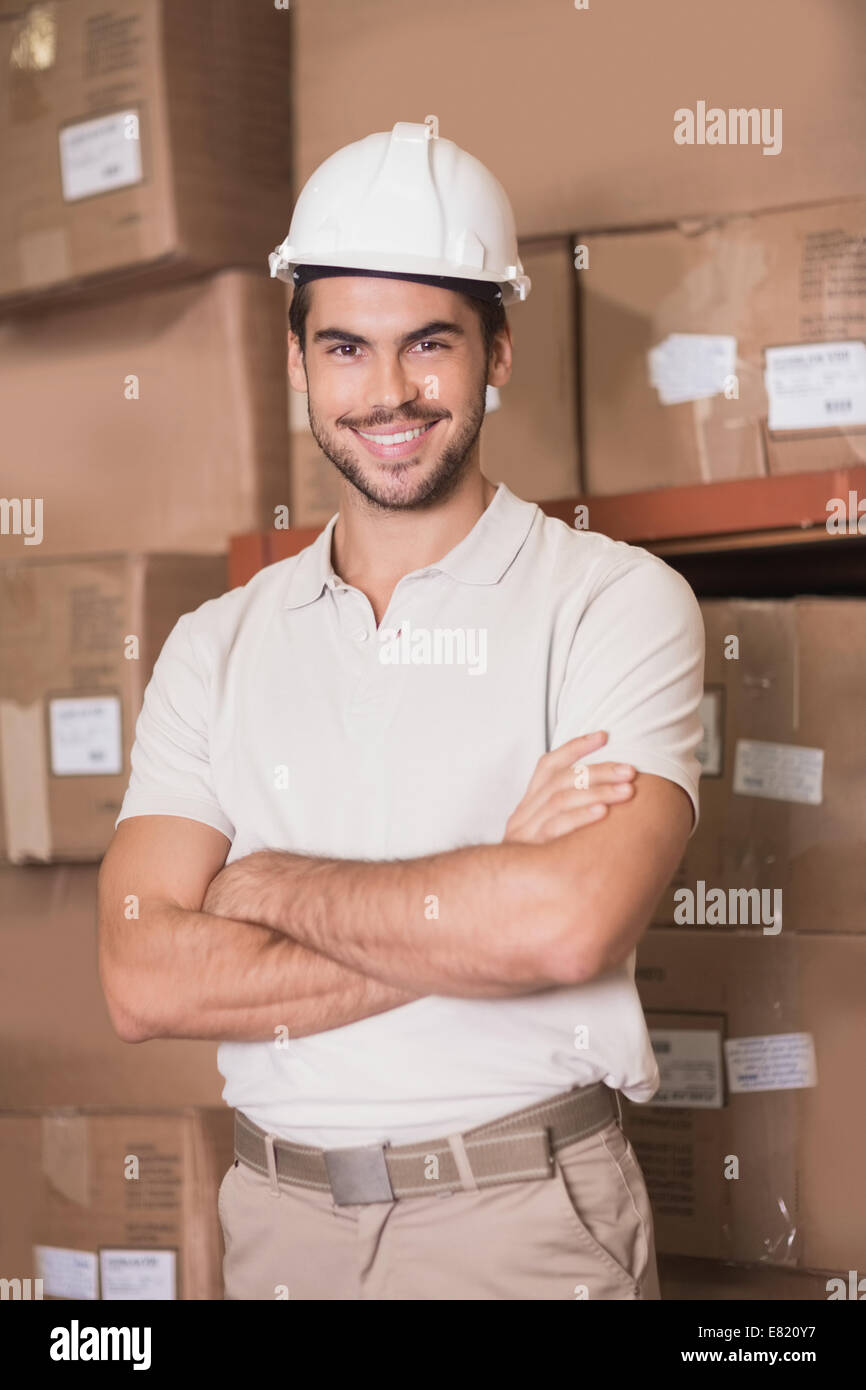 Worker wearing hard hat in warehouse Stock Photo - Alamy