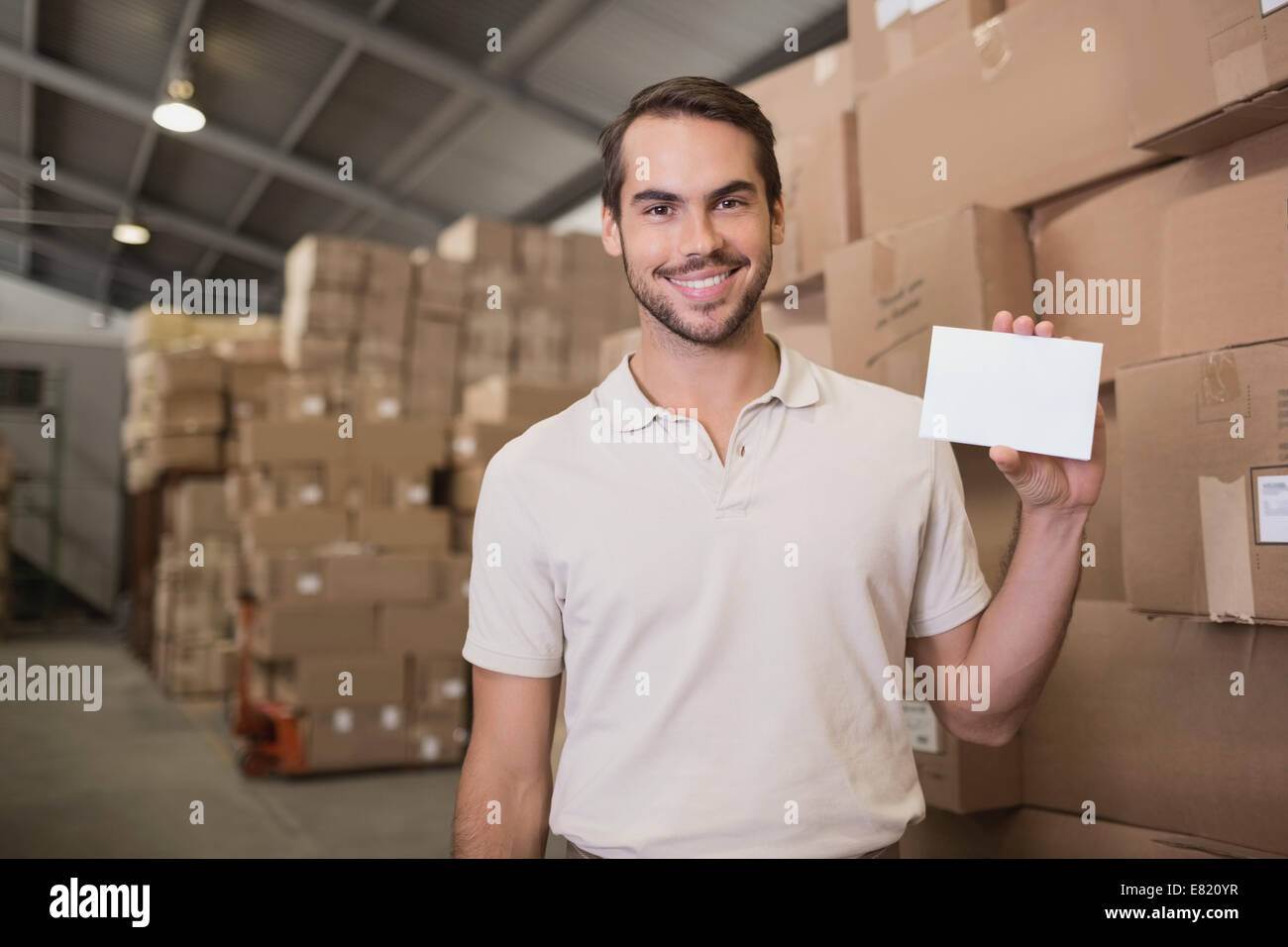 Warehouse worker holding blank paper Stock Photo - Alamy