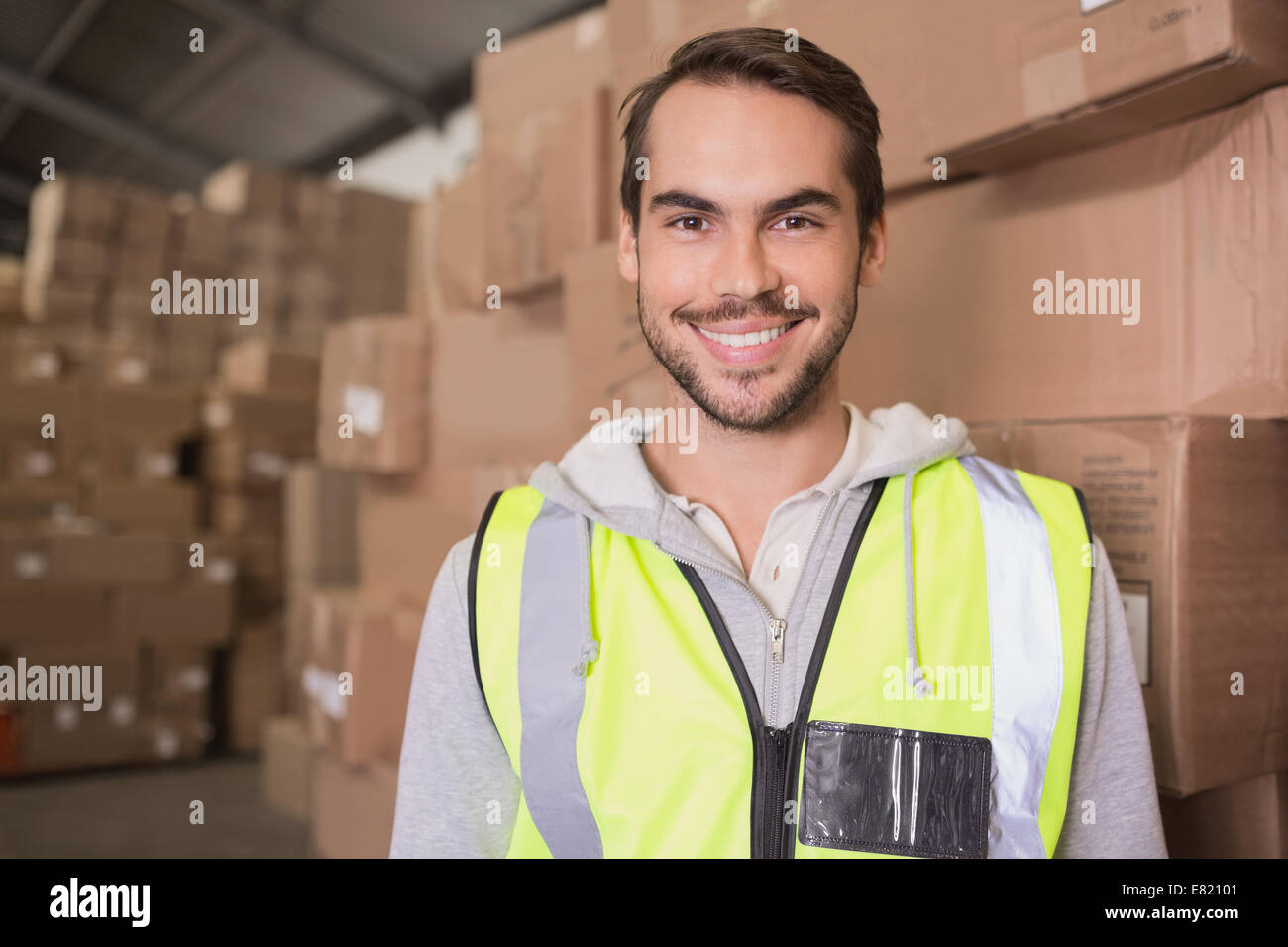 Smiling manual worker in warehouse Stock Photo - Alamy