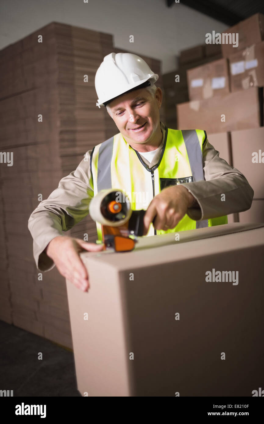 Worker preparing goods for dispatch Stock Photo - Alamy