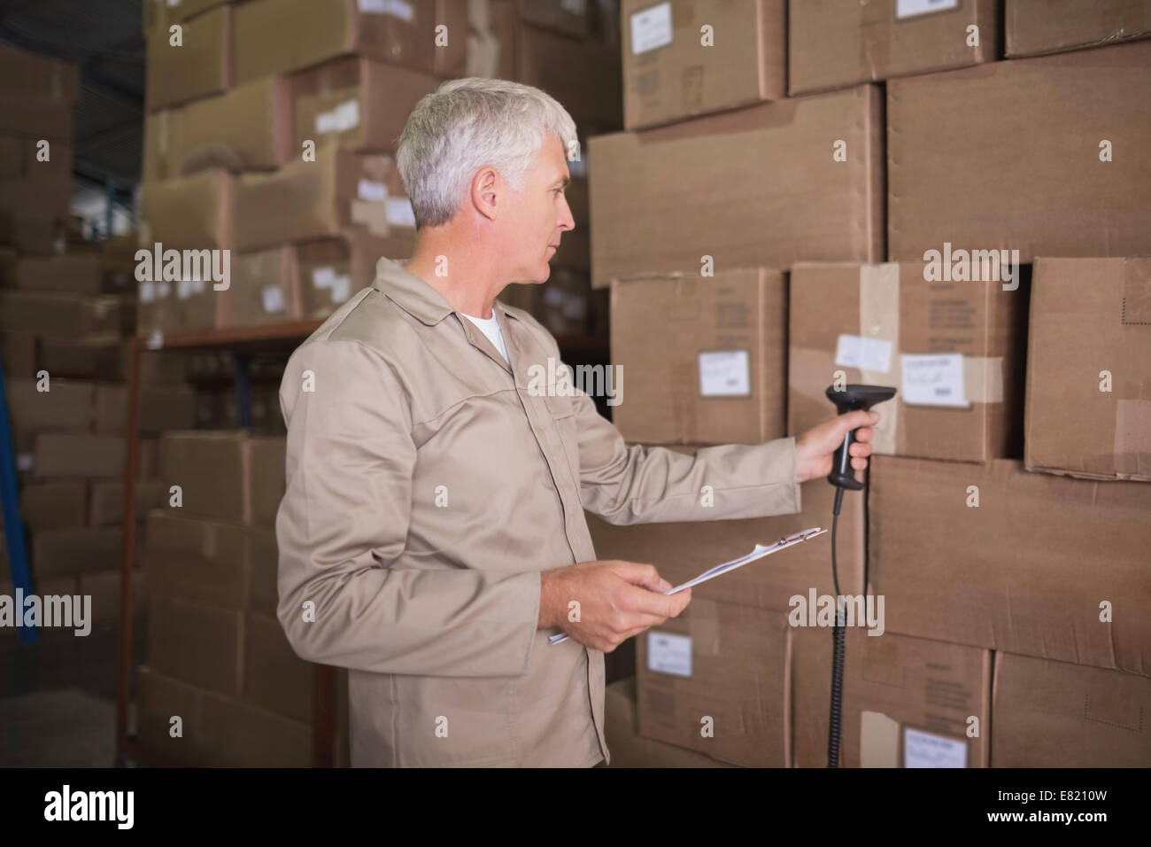 Worker scanning package in warehouse Stock Photo - Alamy