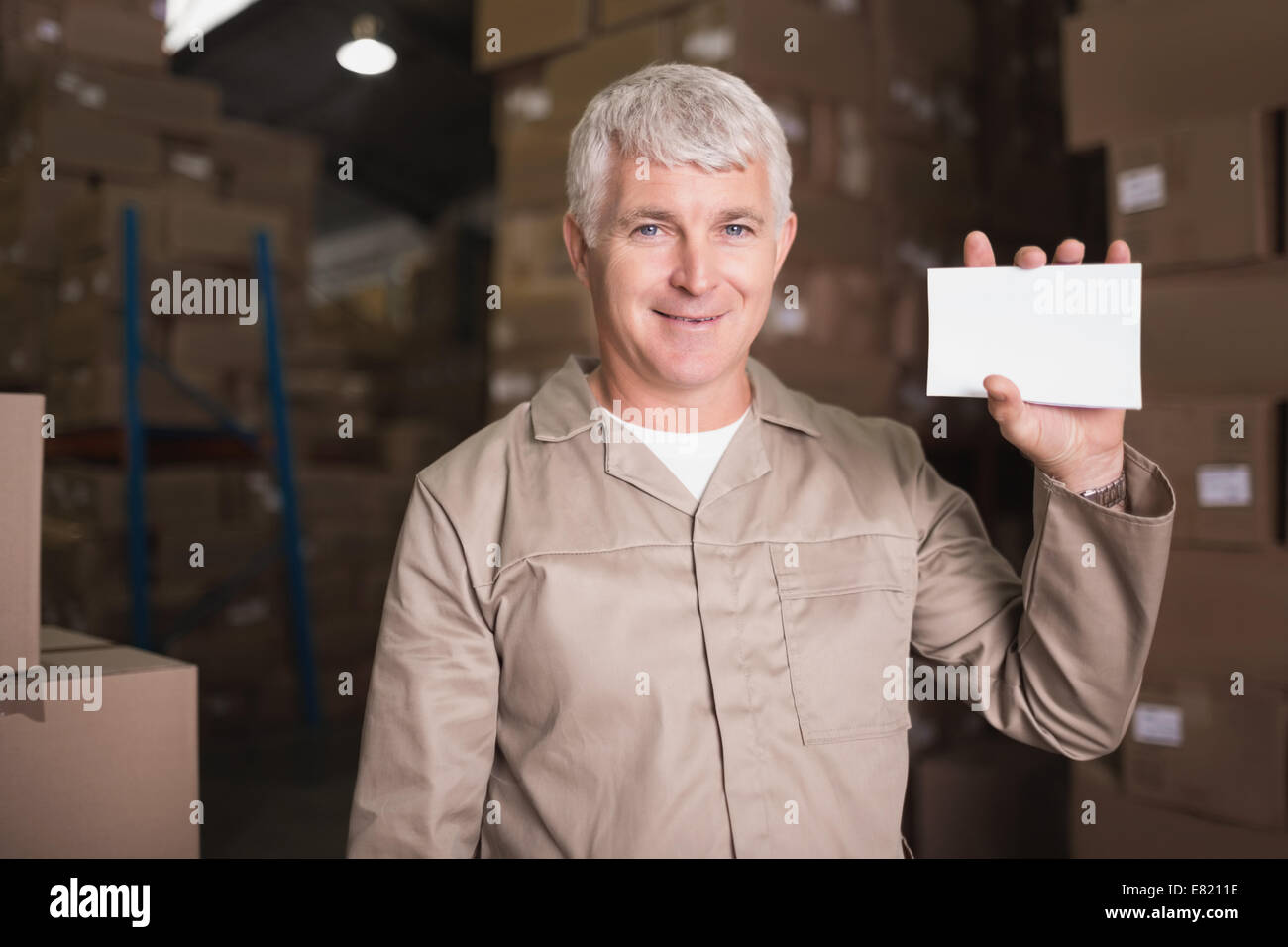 Warehouse worker holding blank paper Stock Photo - Alamy