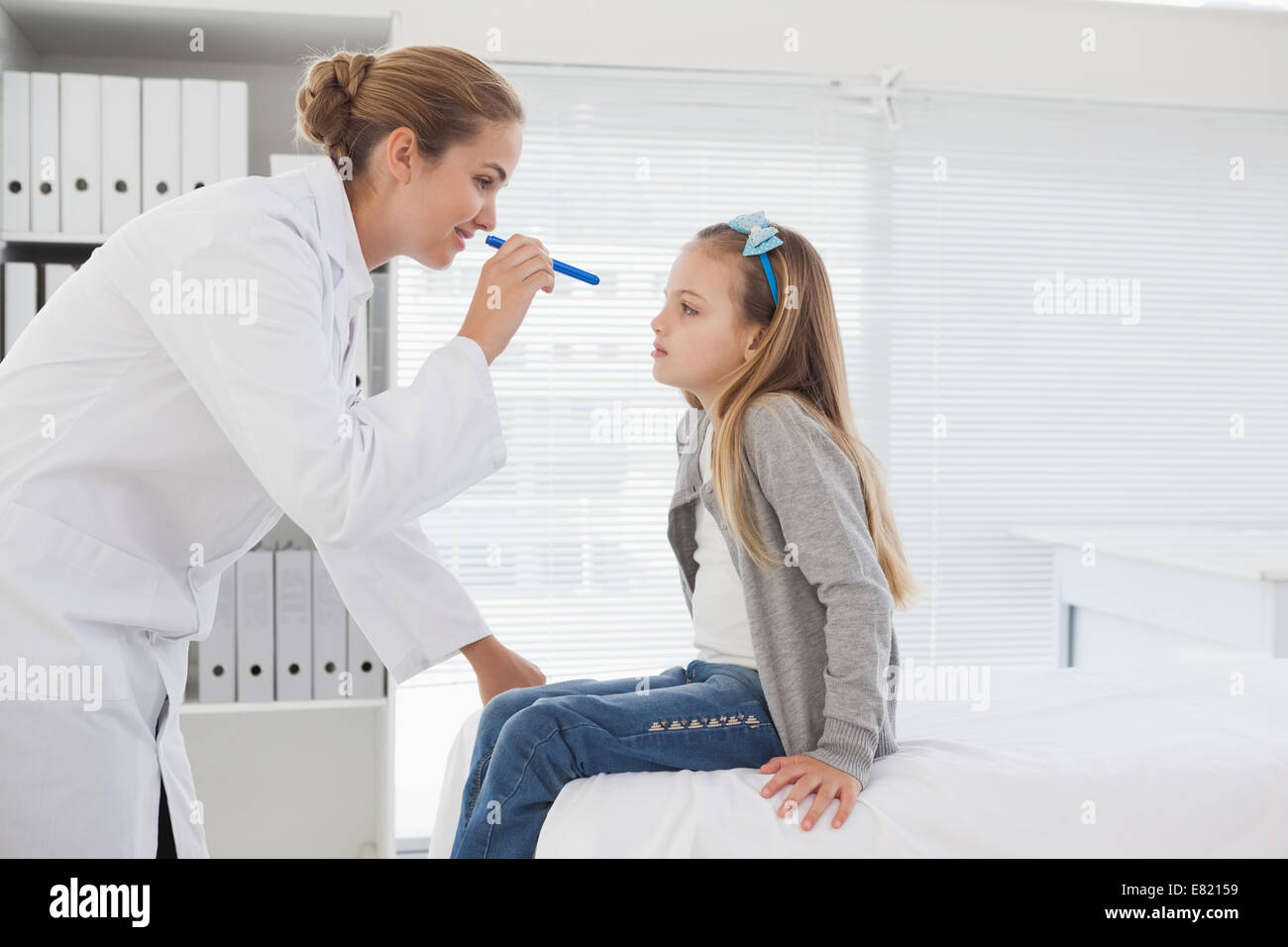 Doctor checking patients eyes Stock Photo - Alamy