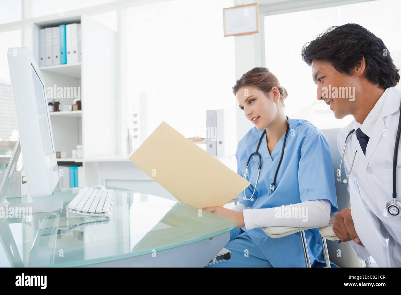 Doctor checking notes hi-res stock photography and images - Alamy