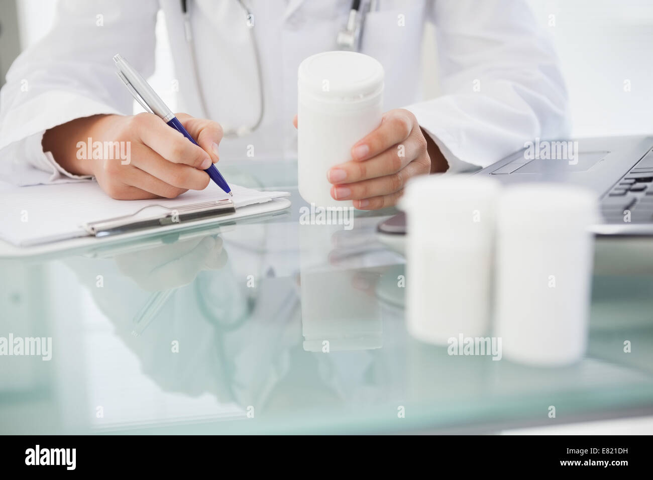 Doctor writing out prescriptions Stock Photo - Alamy