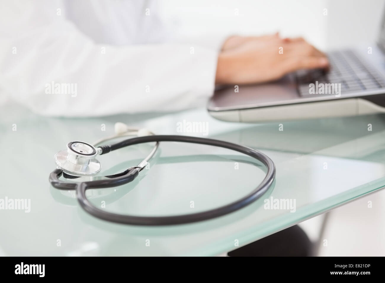 Doctor typing on laptop Stock Photo - Alamy