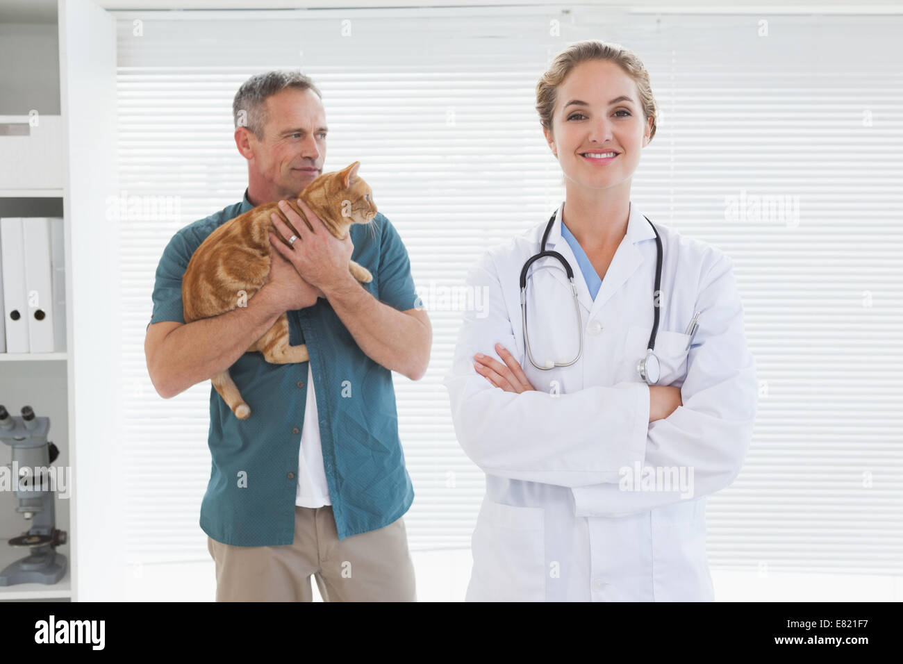 Smiling vet looking at the camera Stock Photo - Alamy