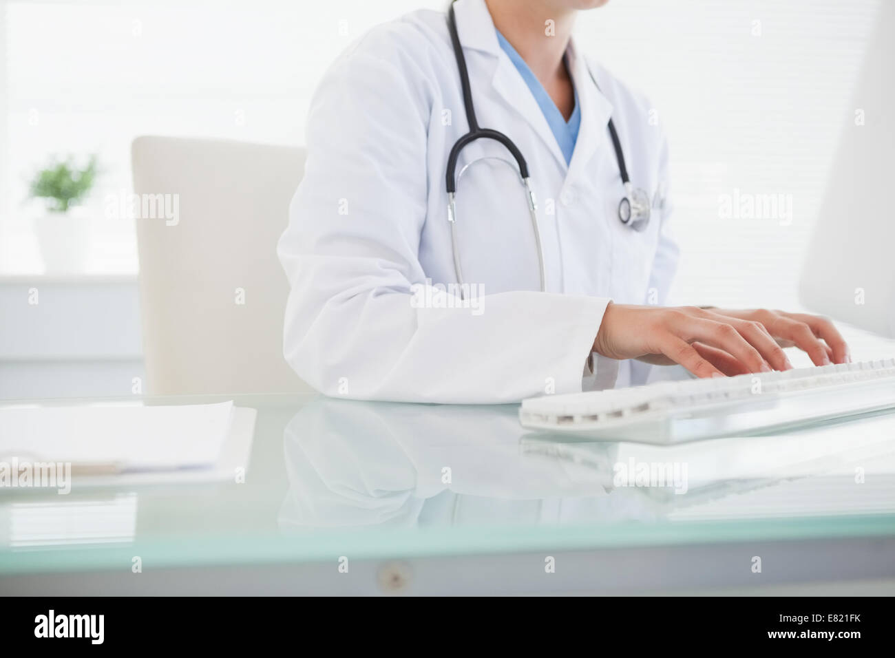 Doctor typing on her laptop Stock Photo - Alamy