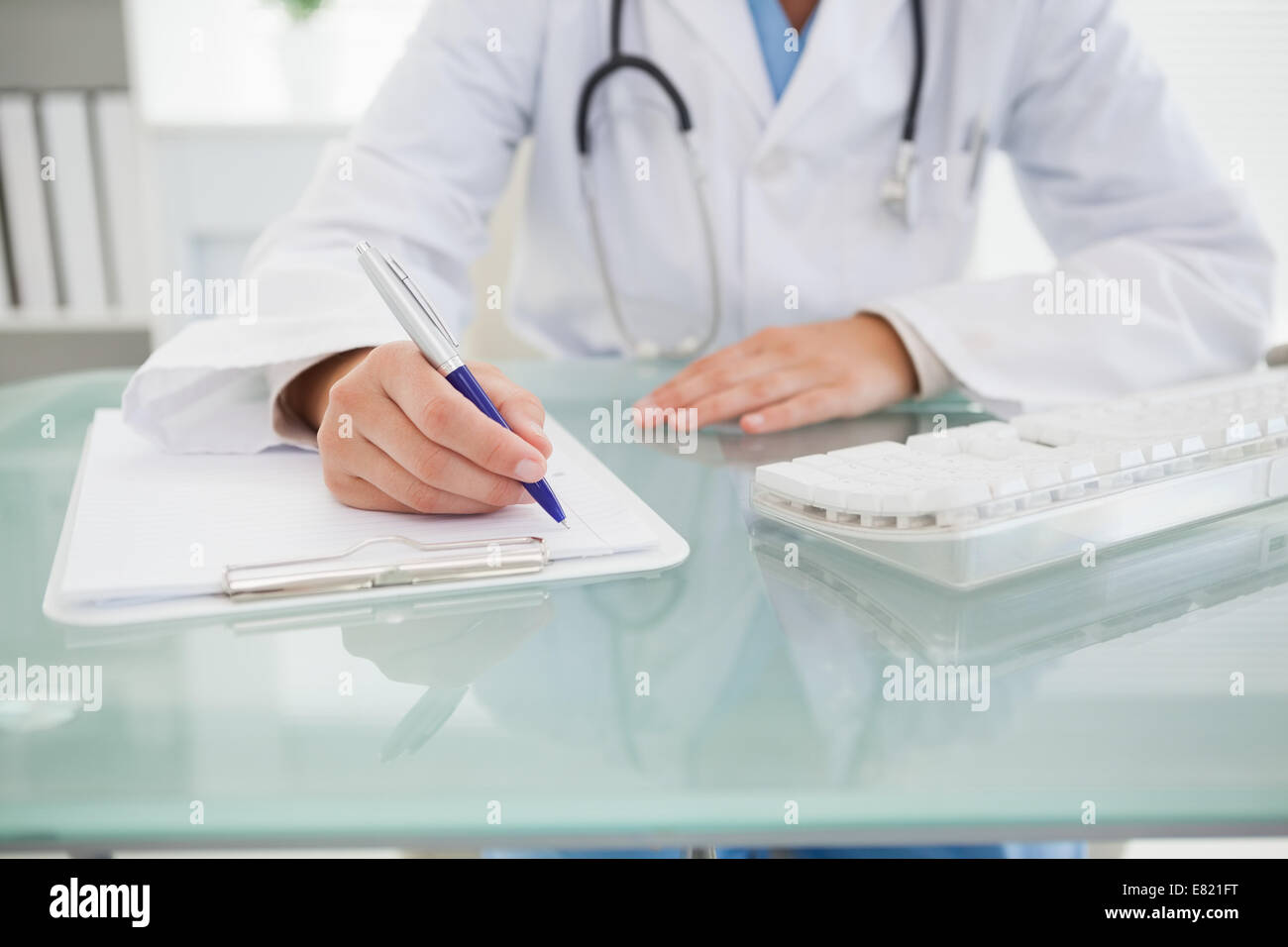 Doctor writing down some notes Stock Photo - Alamy