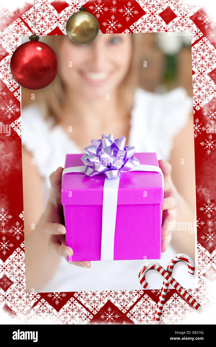 Young woman holding a present sitting on the floor Stock Photo - Alamy