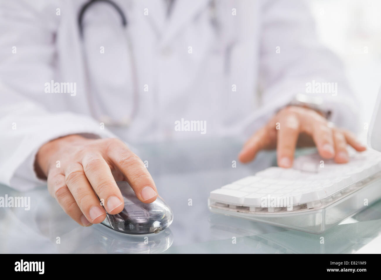 Mature adult doctor typing on hi-res stock photography and images - Alamy