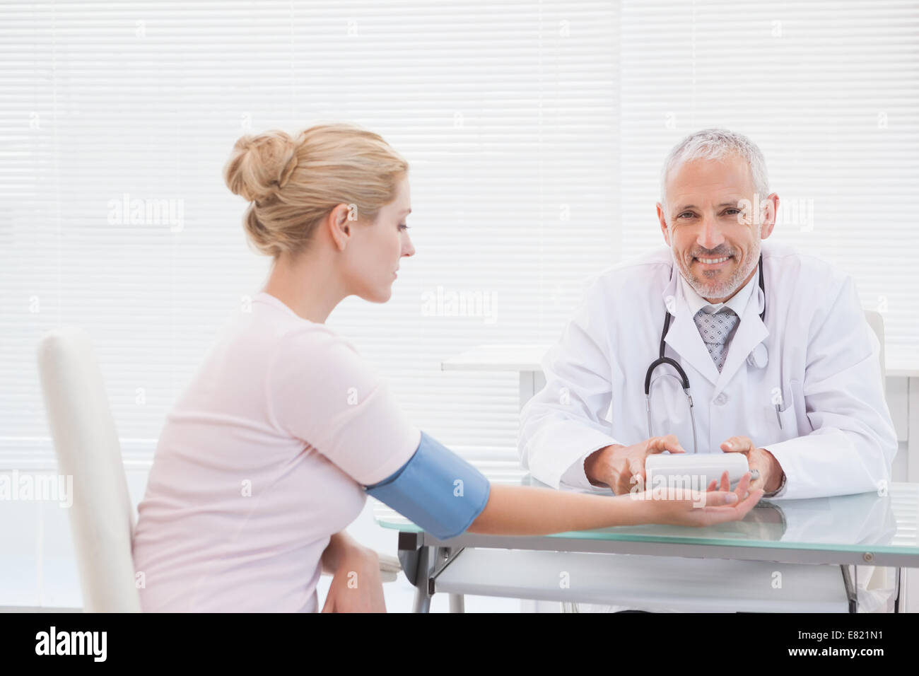 Doctor doing test at his patient Stock Photo - Alamy
