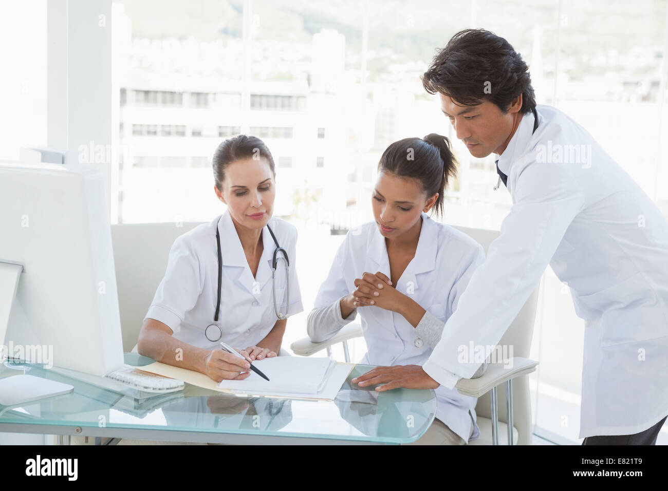 Doctors reviewing notes together Stock Photo - Alamy