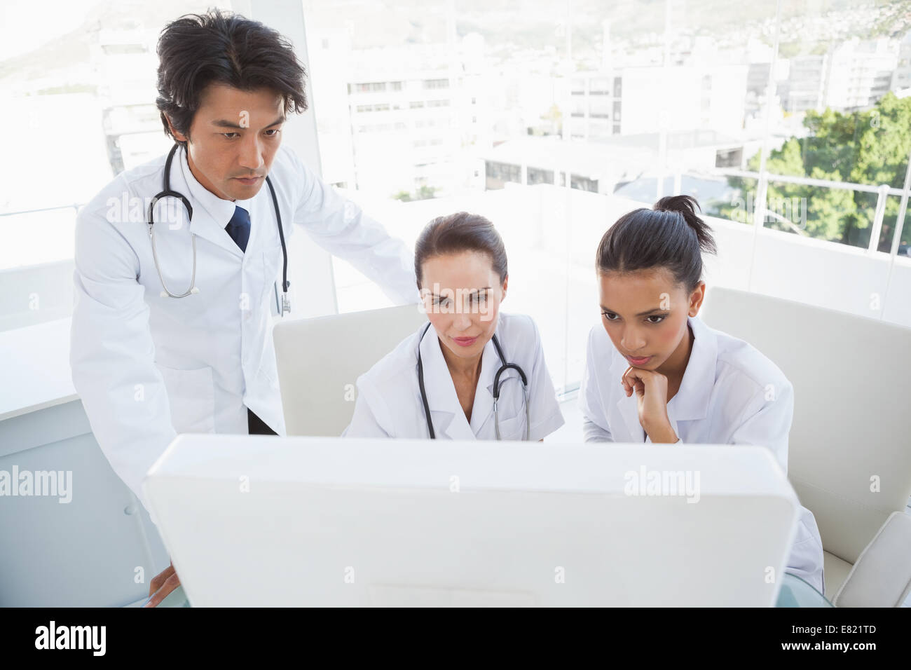 Hard working doctors reviewing notes Stock Photo - Alamy