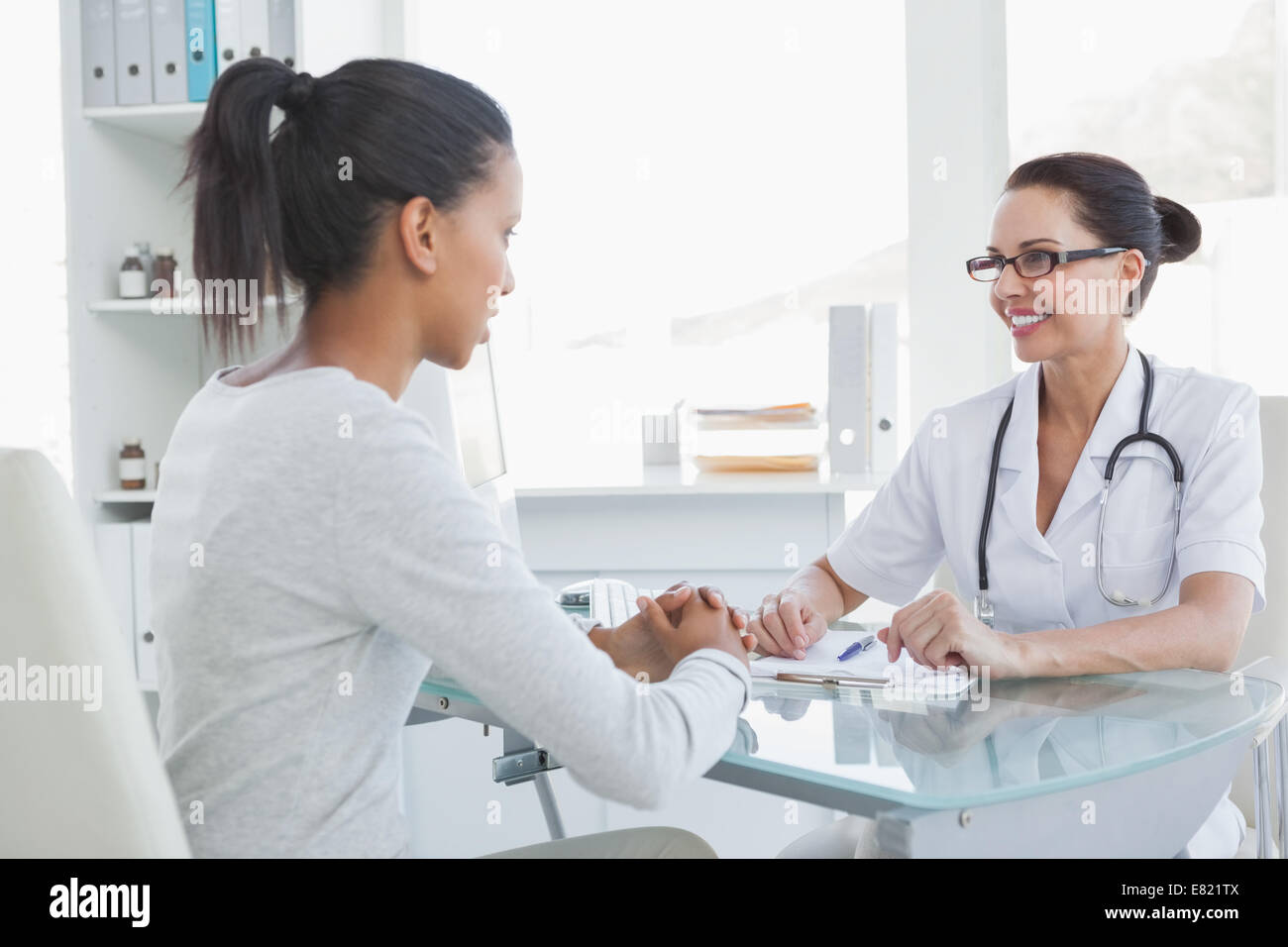 Smiling doctor talking with a patient Stock Photo - Alamy