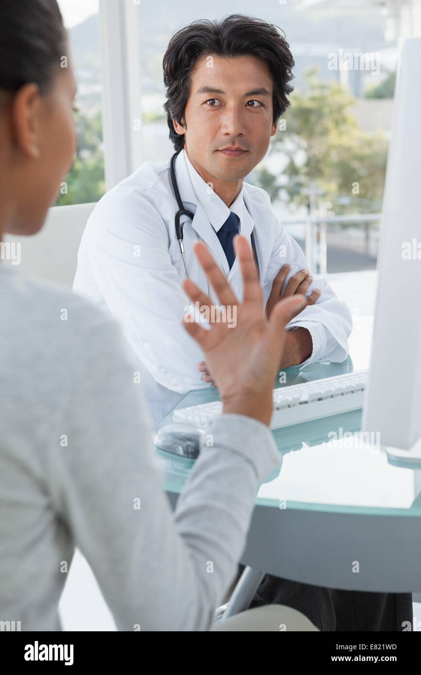 Doctor listening to his patient Stock Photo - Alamy