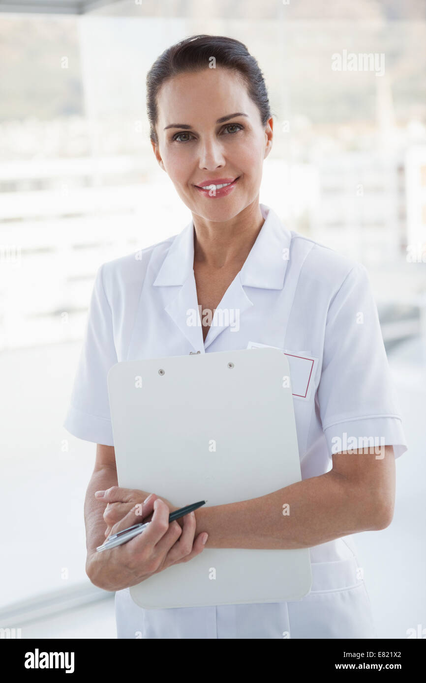 Doctor holding her work chart Stock Photo - Alamy