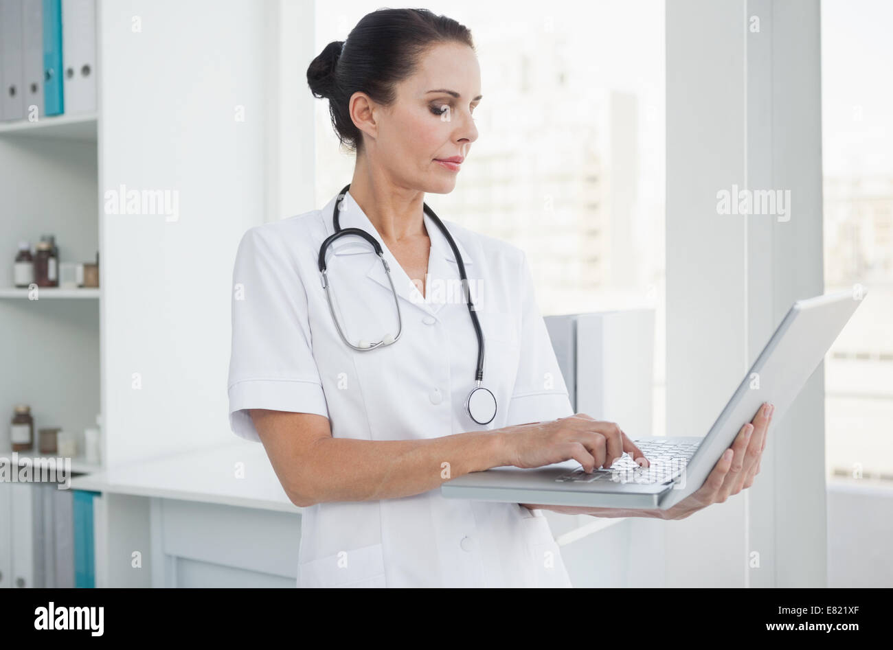 Doctor using her laptop at work Stock Photo - Alamy