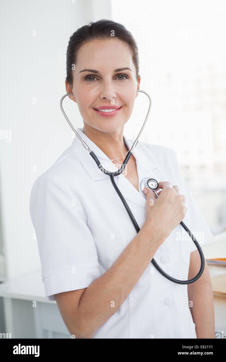 Doctor checking her own heartbeat Stock Photo - Alamy