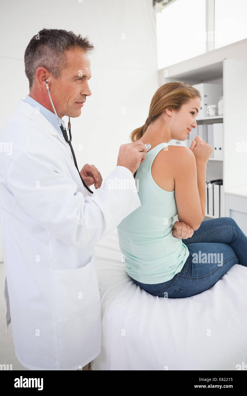 Doctor using his stethoscope Stock Photo - Alamy