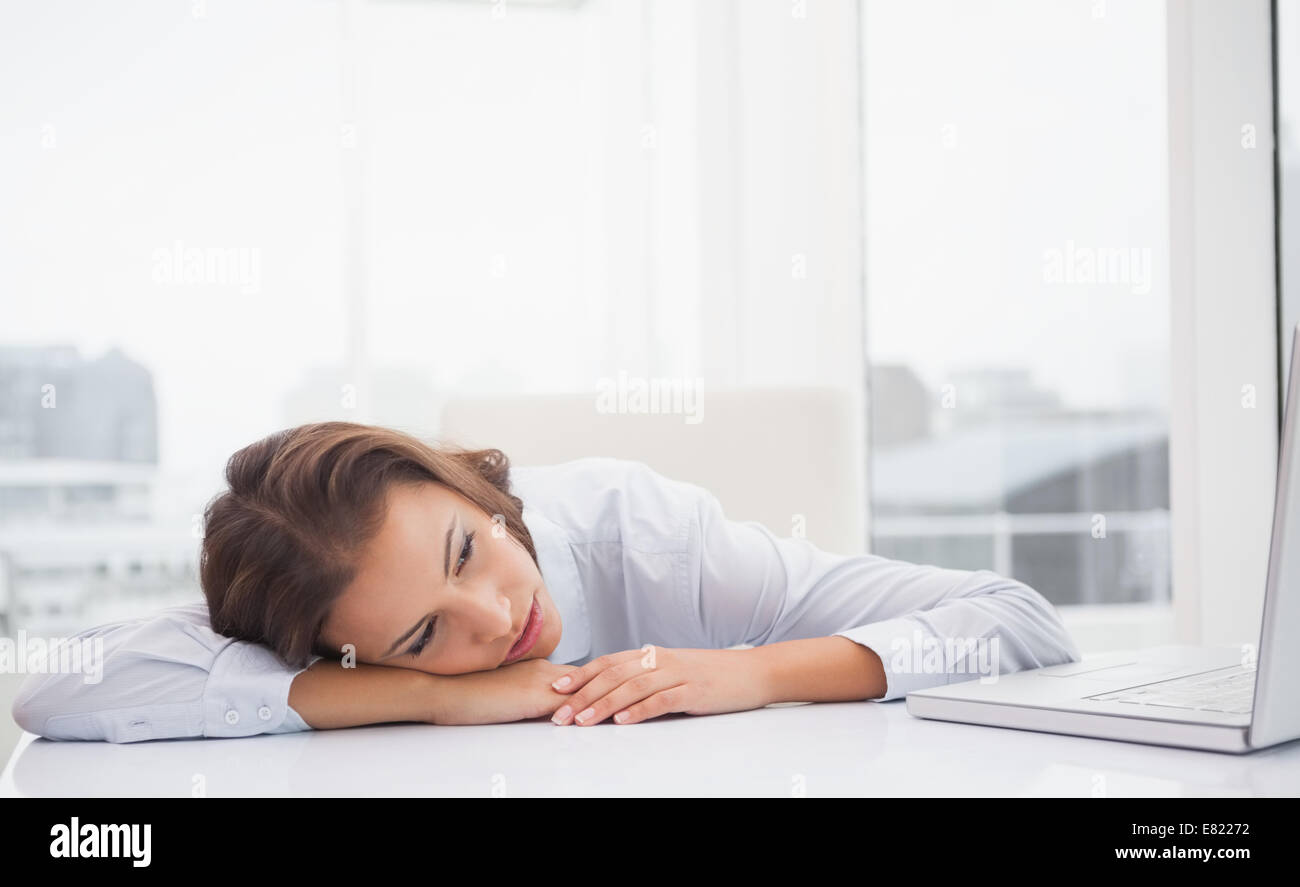 Tired businesswoman resting at her desk Stock Photo - Alamy