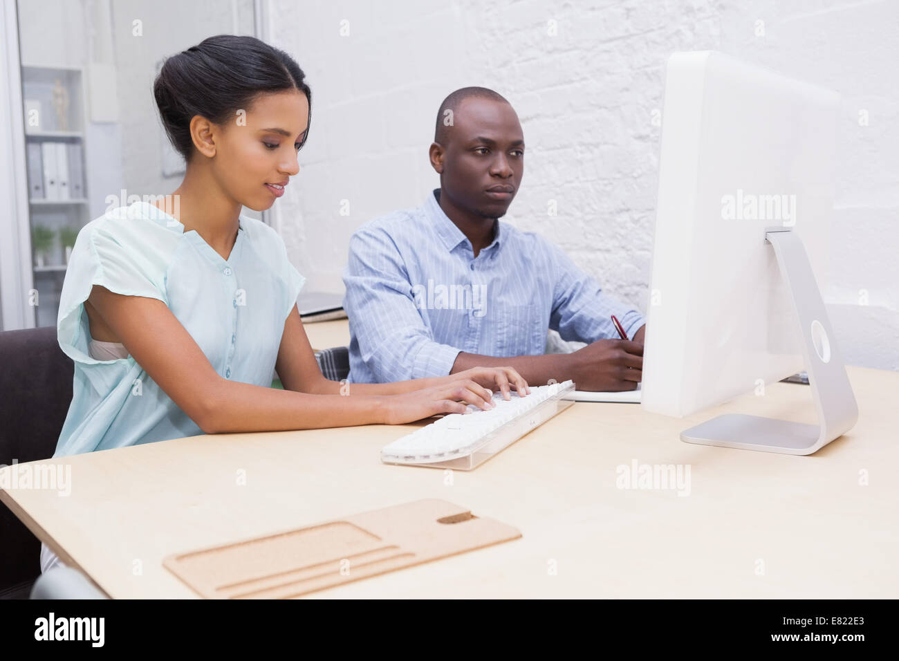 Business team working together on laptop Stock Photo - Alamy