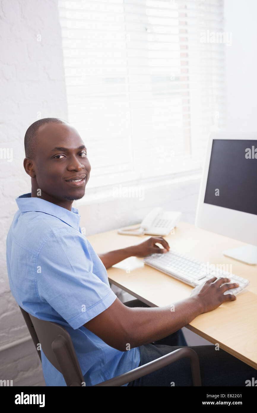 Smiling bussinessman typing on his computer Stock Photo - Alamy
