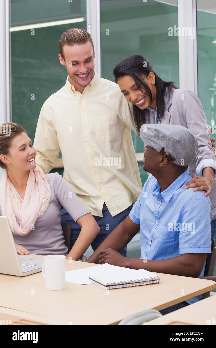 Smiling team of business people having a meeting Stock Photo - Alamy