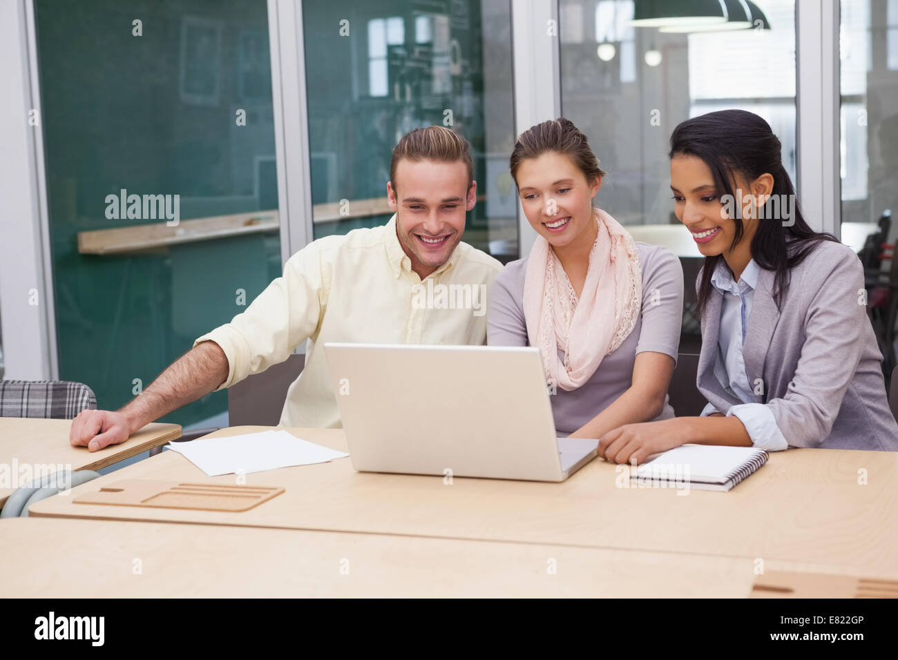 Three happy businessmen working together on a laptop Stock Photo - Alamy