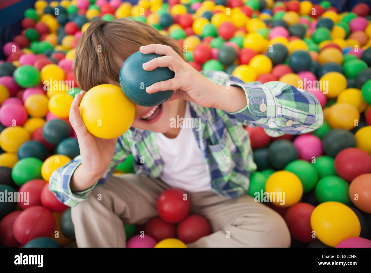 Cute boy smiling in ball pool Stock Photo - Alamy