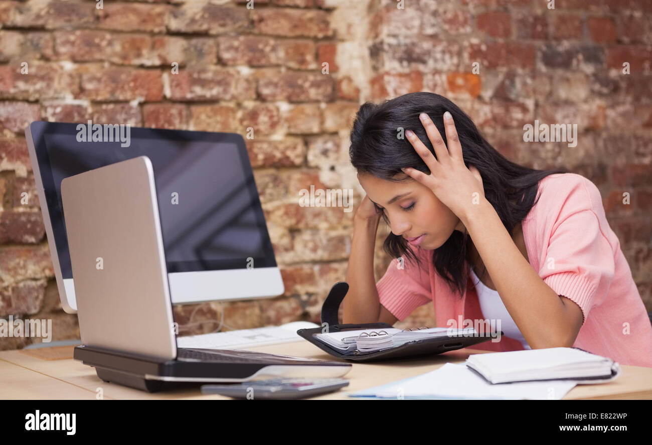 Worried woman with head in hands Stock Photo - Alamy