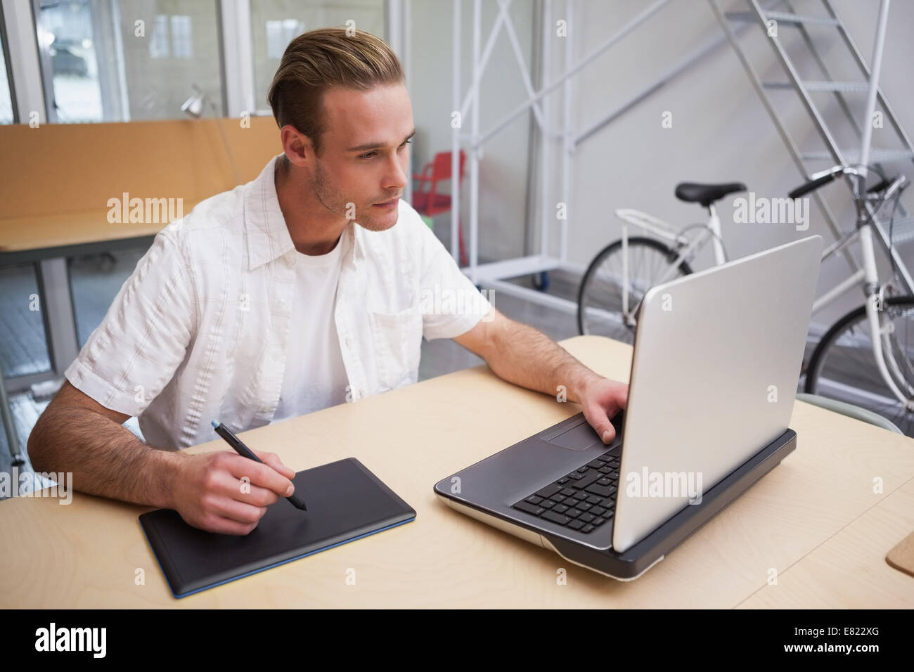 Man using graphics tablet to do work Stock Photo - Alamy