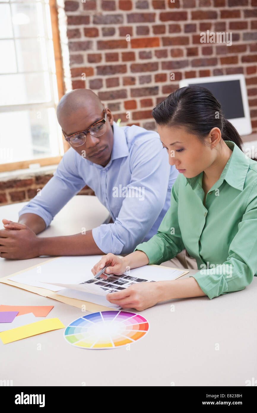 Casual business team working together at desk Stock Photo - Alamy