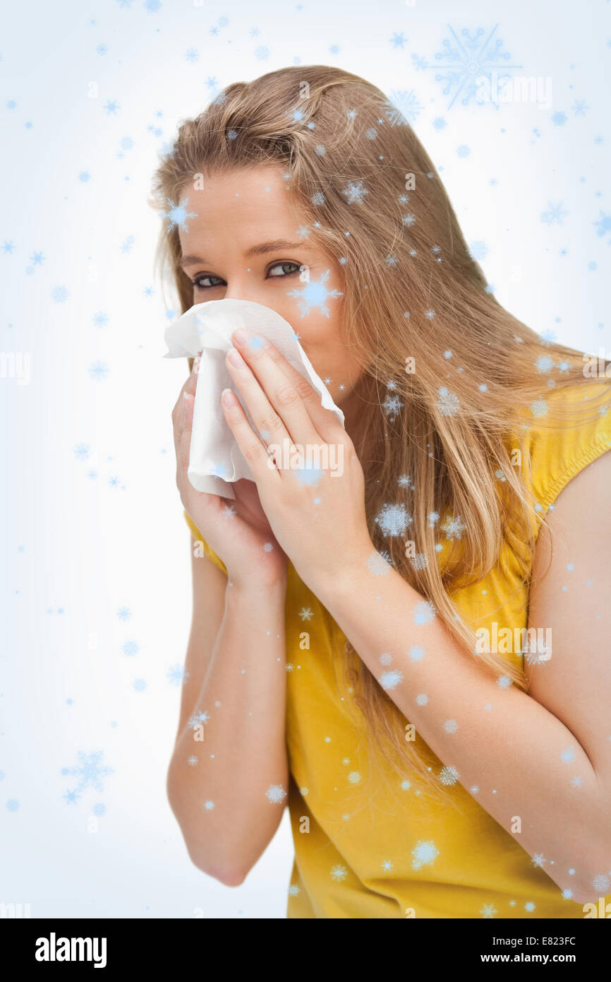 Portrait of a blond woman blowing Stock Photo - Alamy