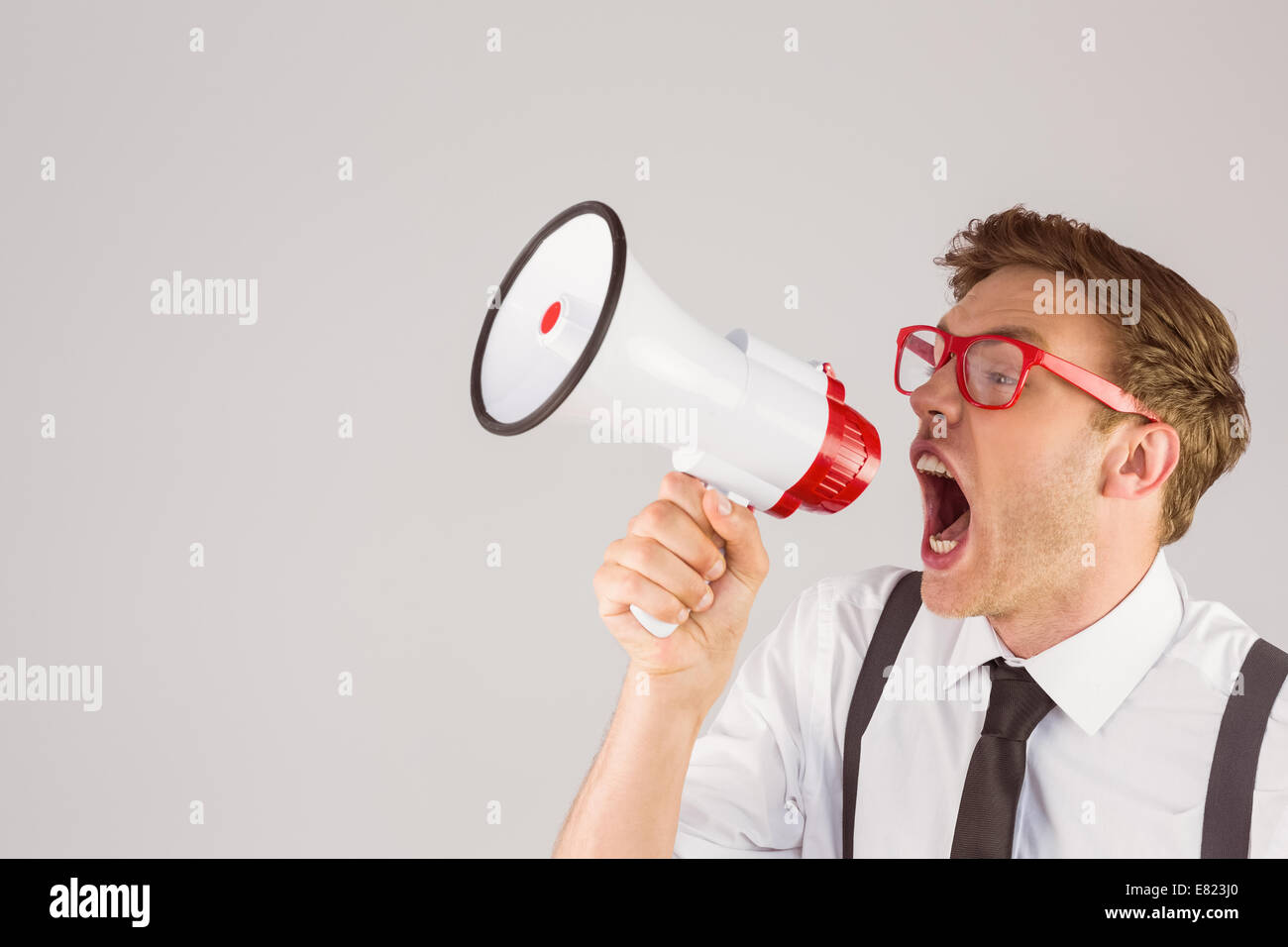 Geeky businessman shouting through megaphone Stock Photo - Alamy