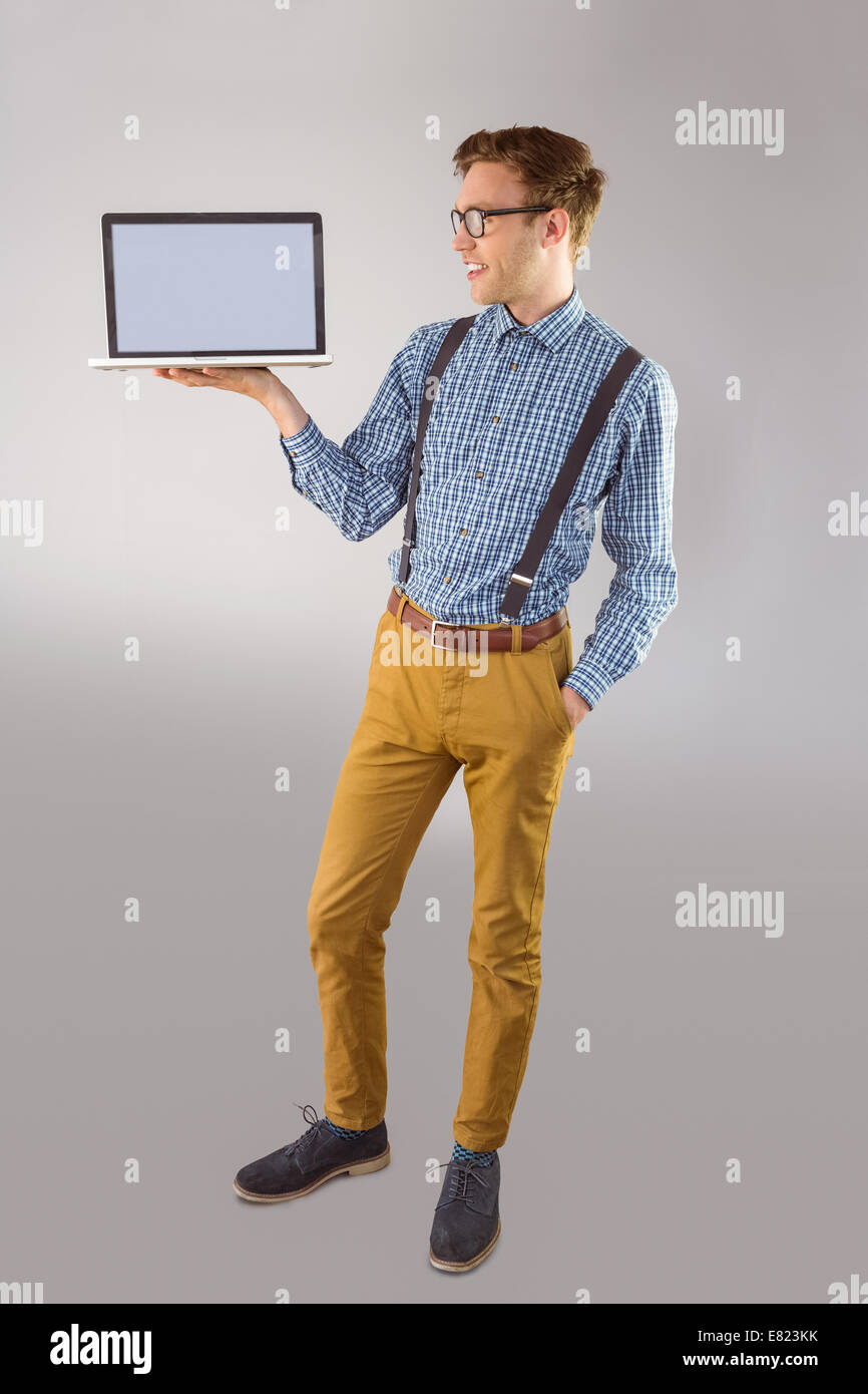 Geeky businessman showing his laptop Stock Photo - Alamy