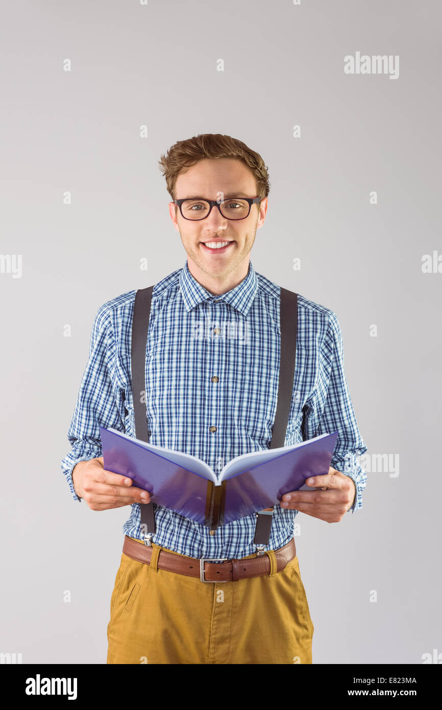 Geeky student reading a book Stock Photo - Alamy