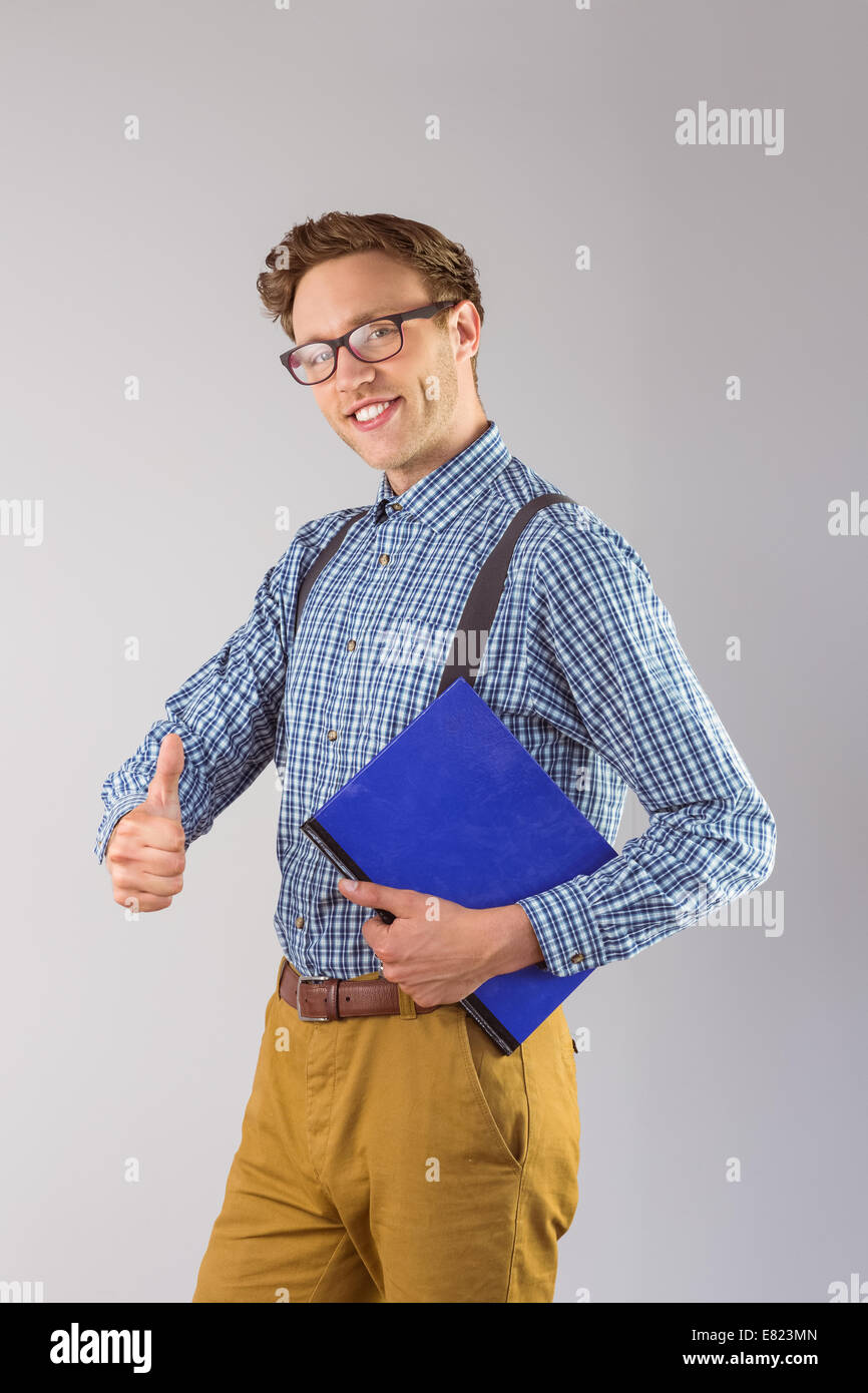 Geeky student holding a notebook Stock Photo - Alamy