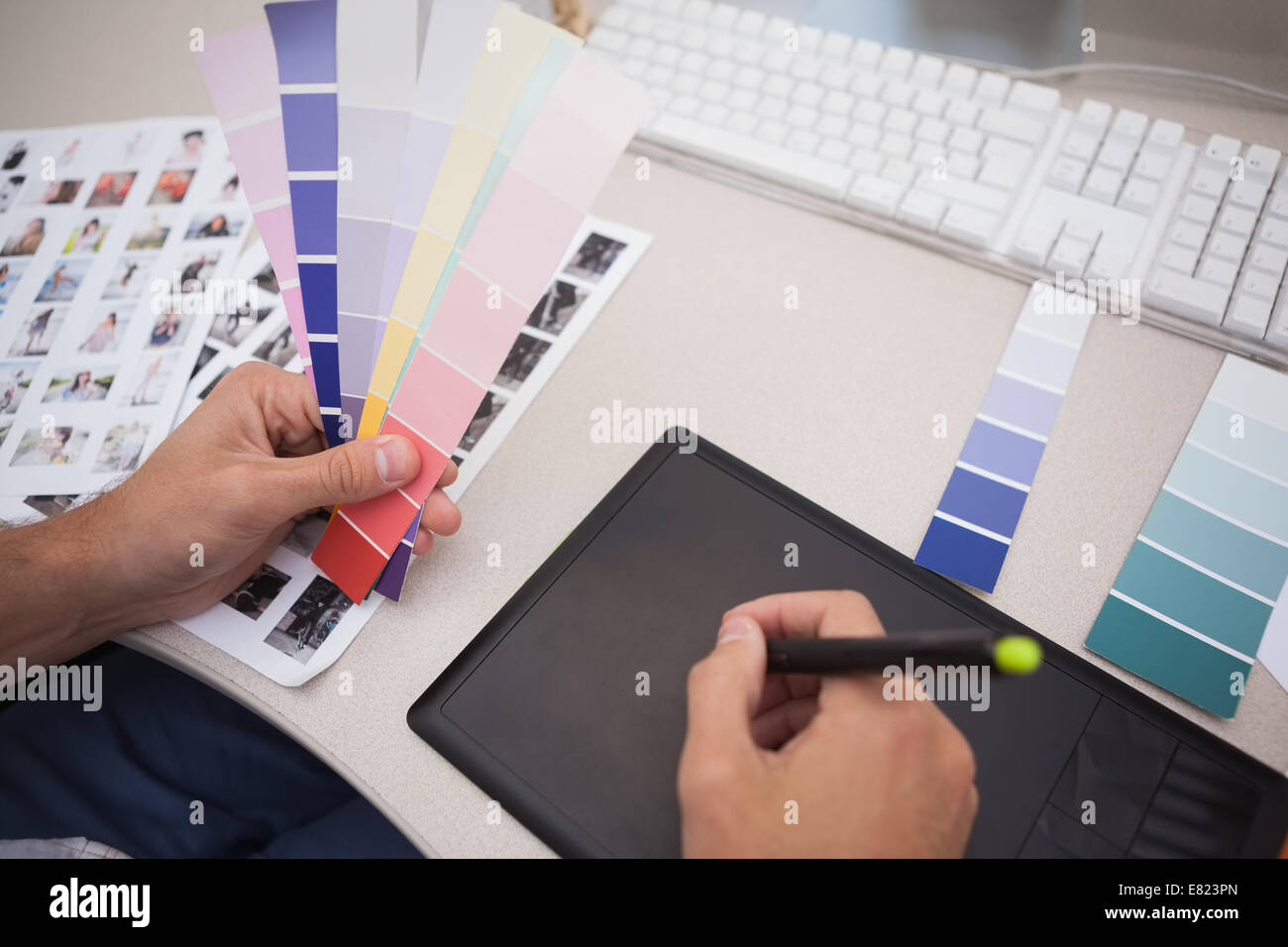 Designer using graphics tablet and colour charts Stock Photo - Alamy