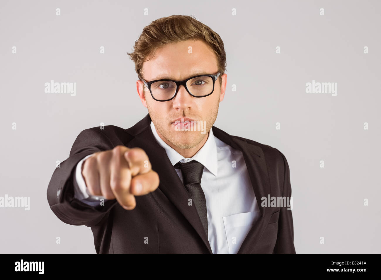 Young serious businessman pointing at camera Stock Photo - Alamy