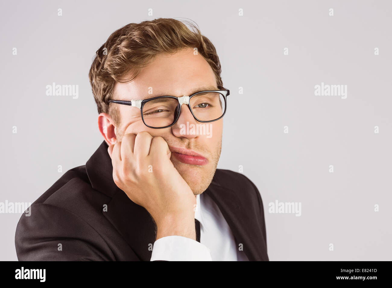 Young geeky businessman looking bored Stock Photo - Alamy