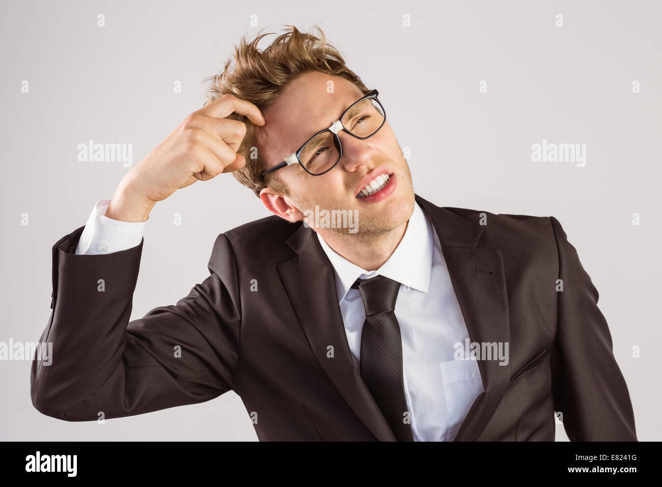 Confused doubtful young man scratching hi-res stock photography and ...