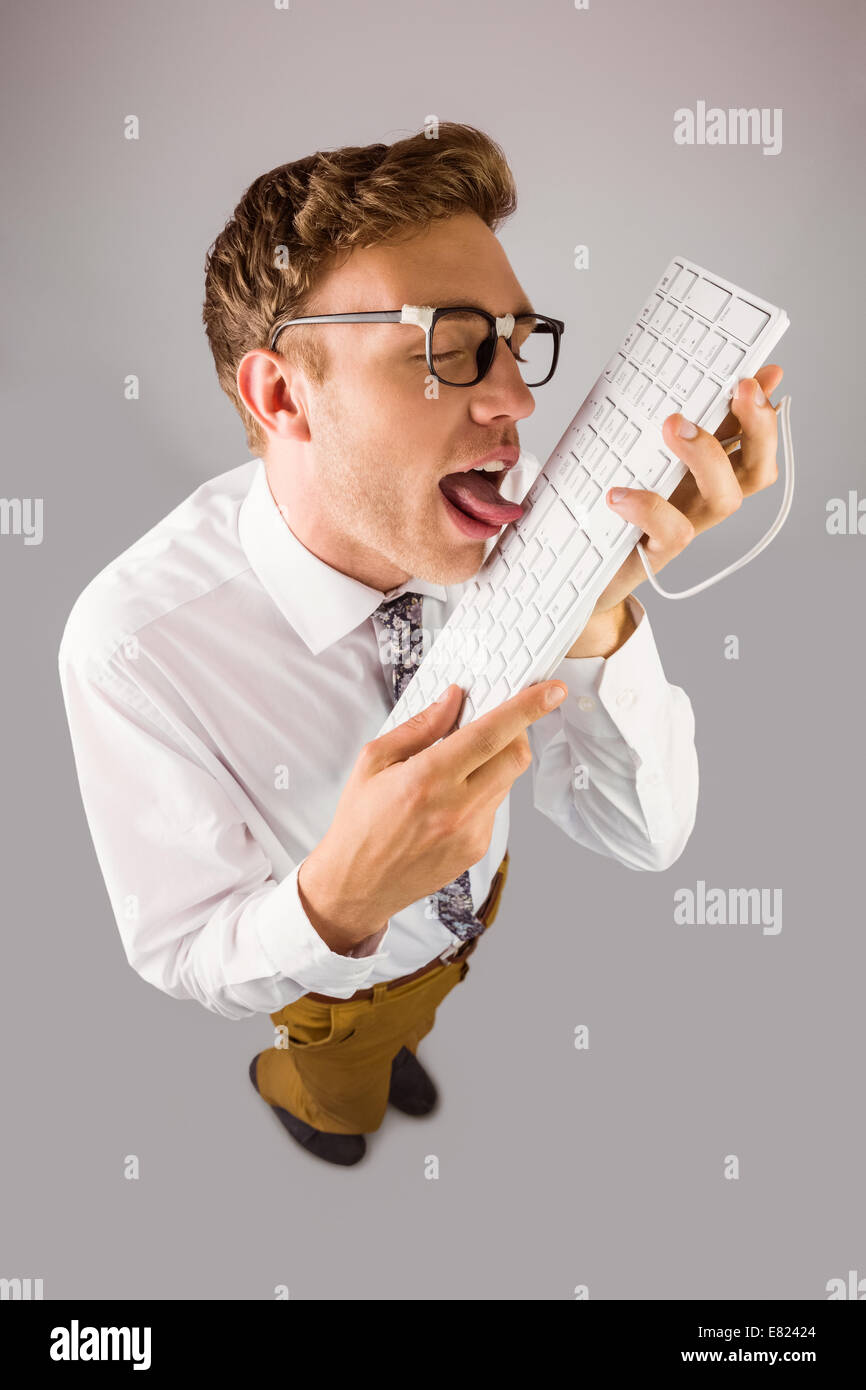 Geeky businessman licking his keyboard Stock Photo - Alamy
