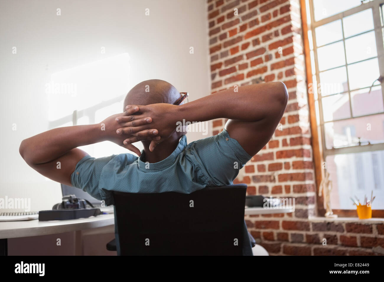 Man leaning back in chair hi-res stock photography and images - Alamy