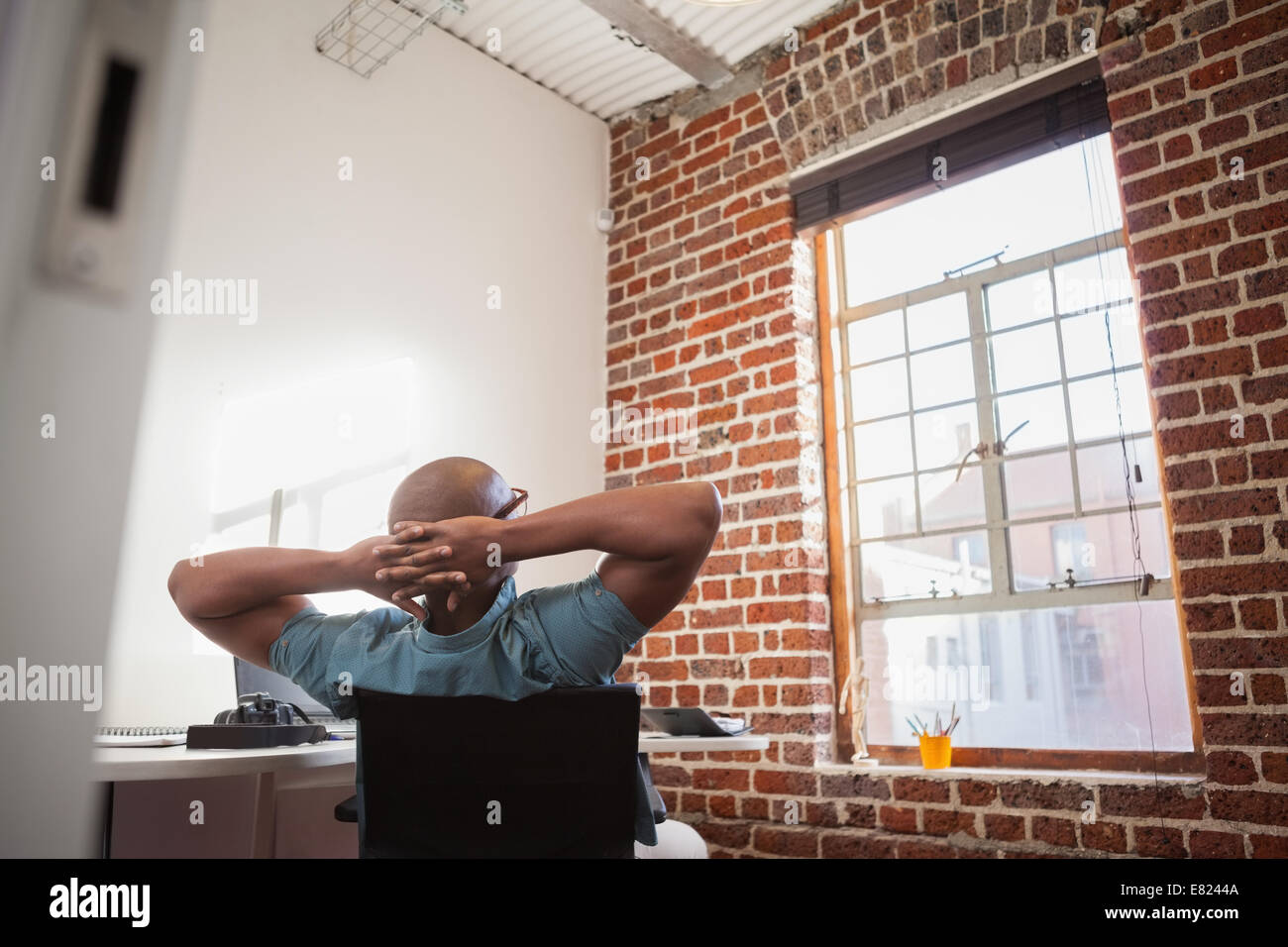 Man leaning back in chair hi-res stock photography and images - Alamy