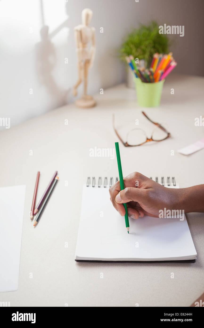 Designer sketching on paper with pencil Stock Photo - Alamy