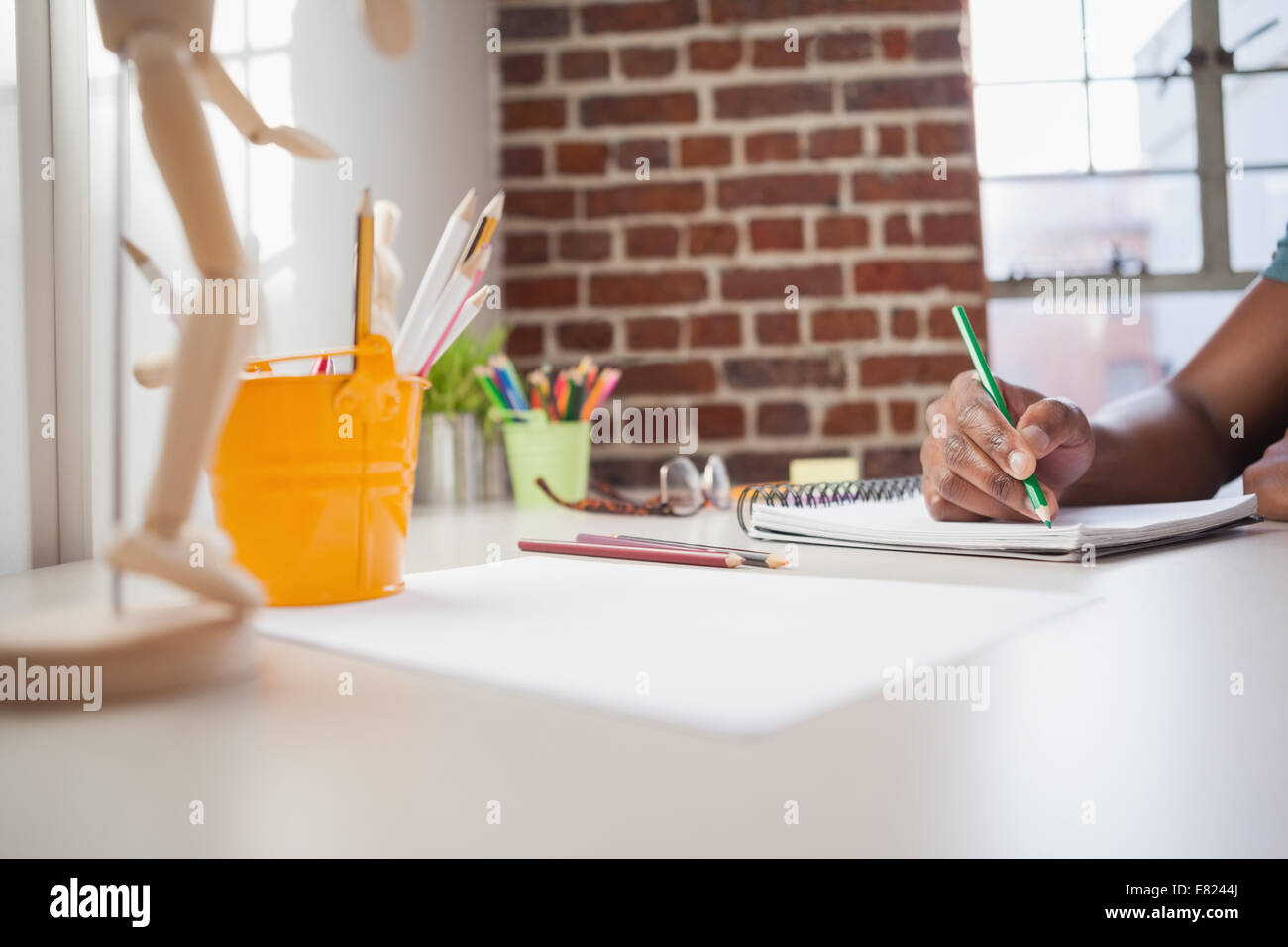 Designer sketching on paper with pencil Stock Photo - Alamy